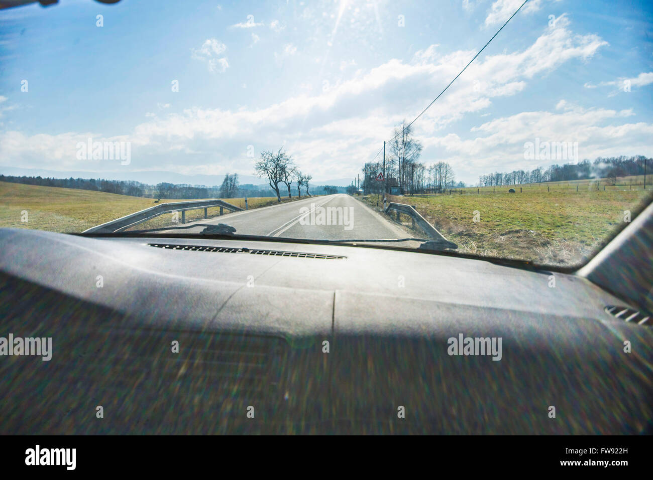 Driving a car in the town wit heavy sun reflection Stock Photo - Alamy