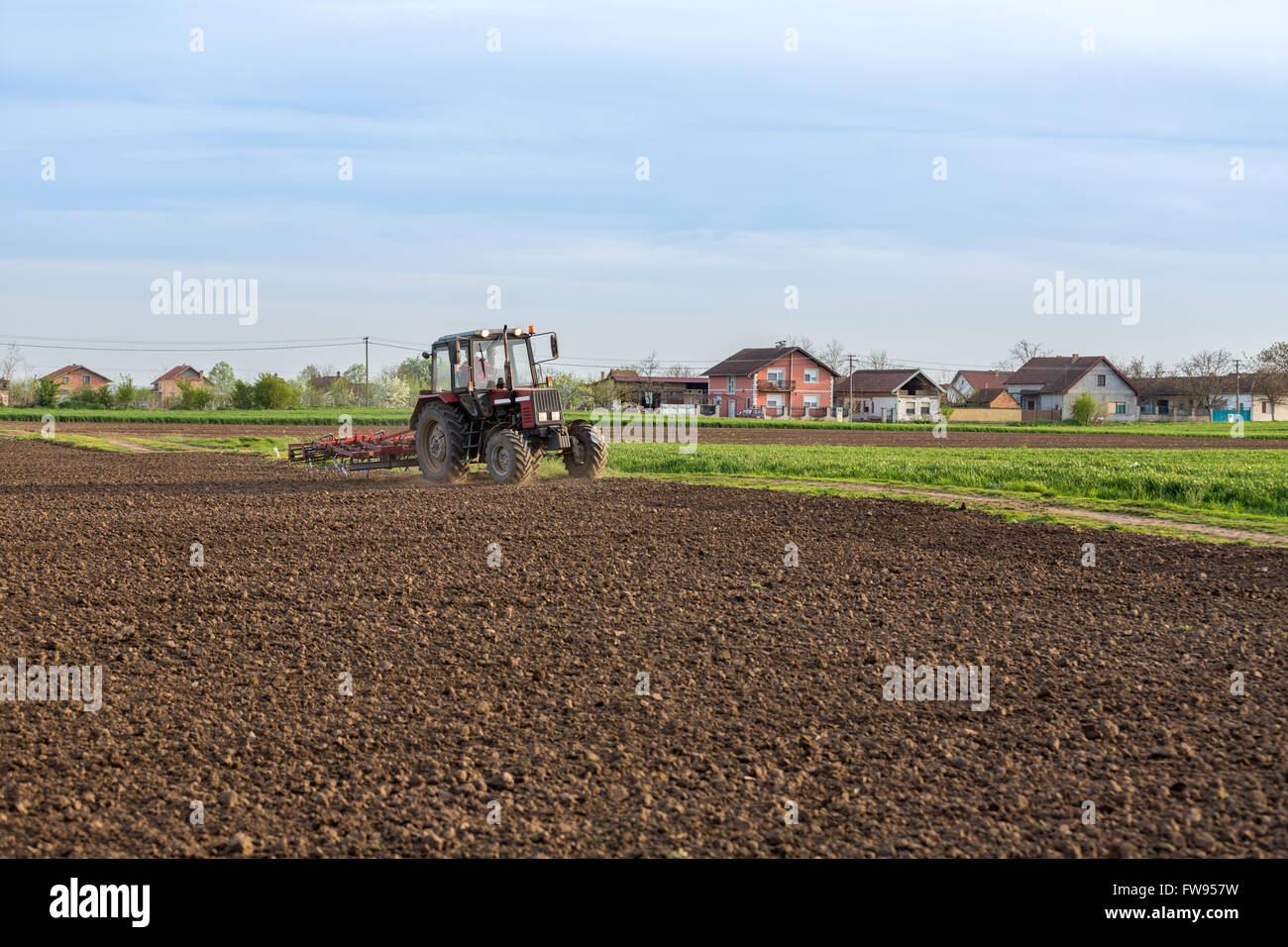 Farmer cultivating arable land before seeding Stock Photo - Alamy