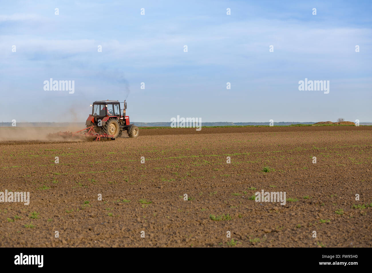 Farmer cultivating arable land before seeding Stock Photo - Alamy