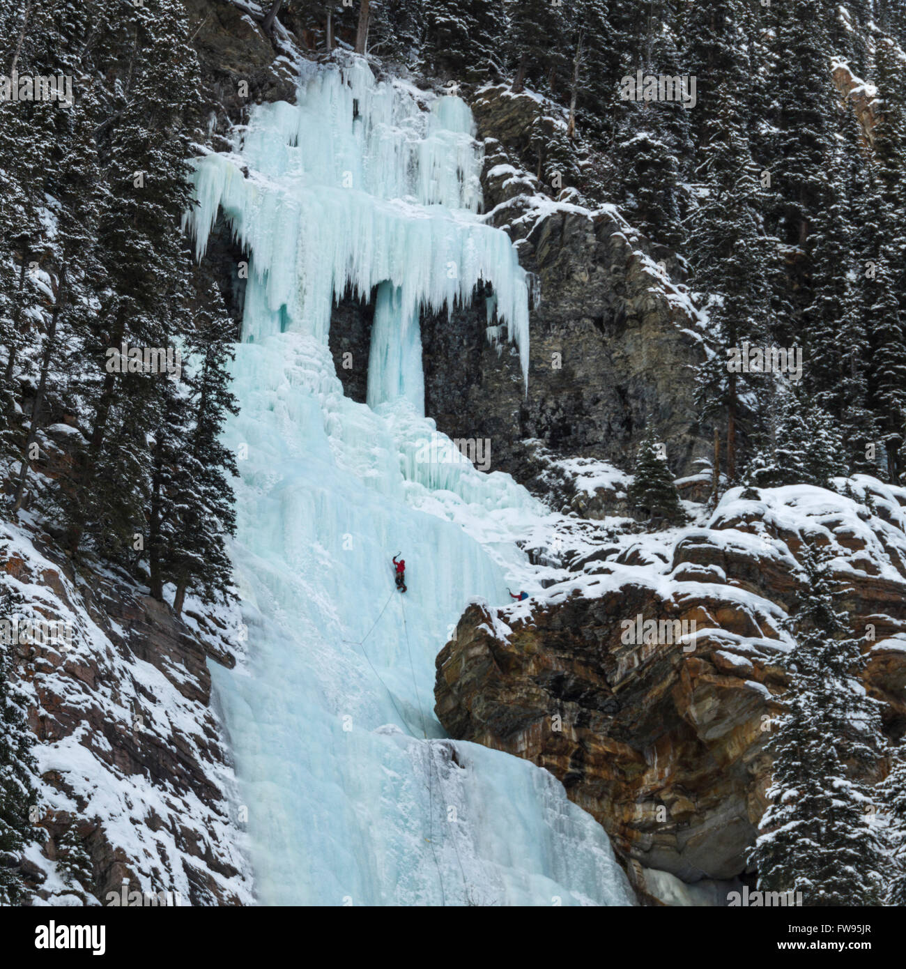 Ice climber on frozen waterfall, Lake Louise, Banff National Park ...