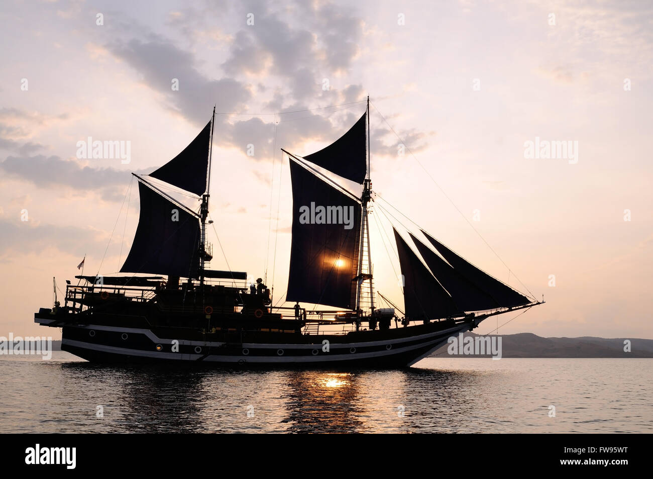 Sailboat with hoisted sails, Indonesia Stock Photo - Alamy