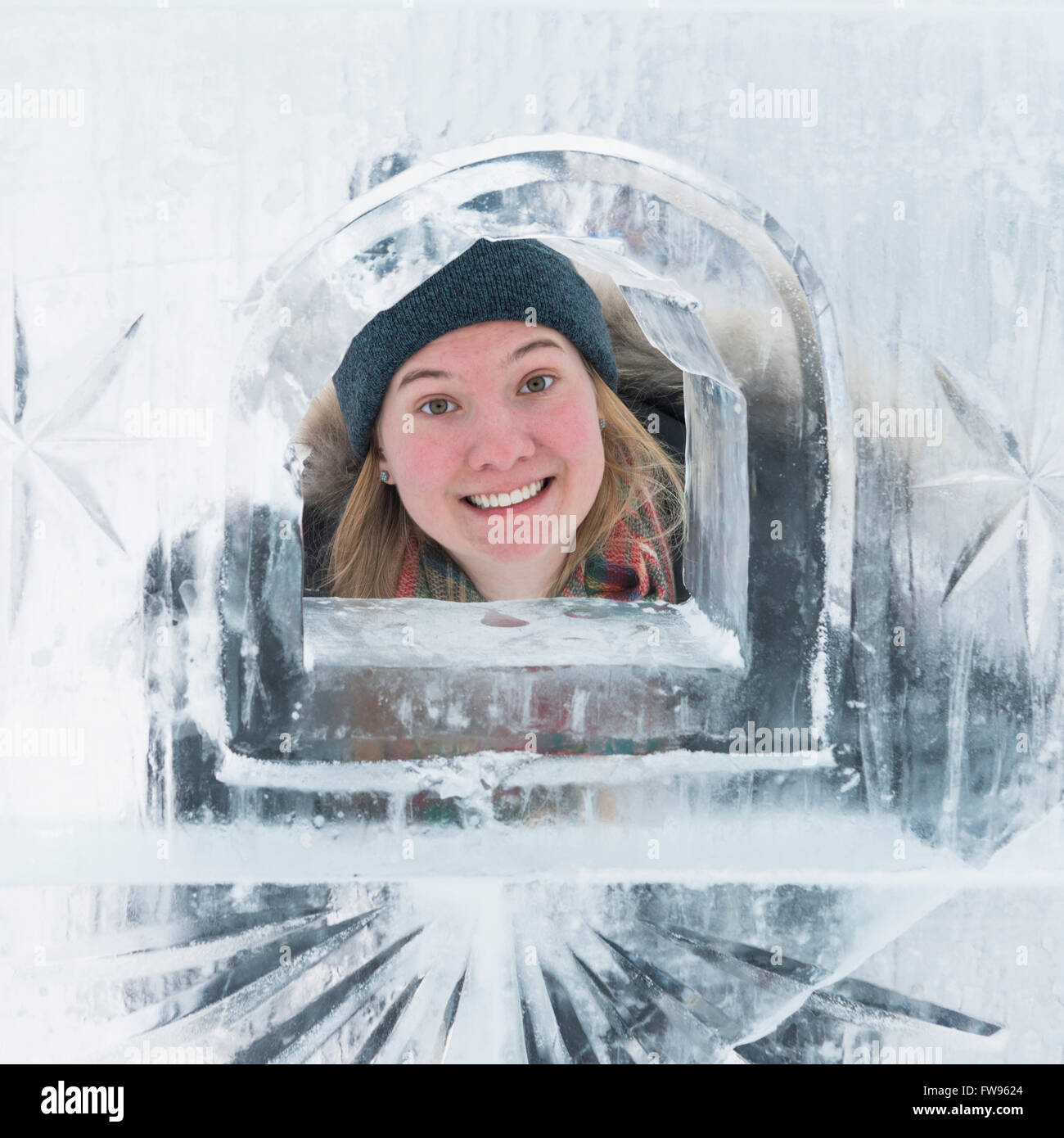 Woman looking through opening in ice castle wall, Banff National Park ...