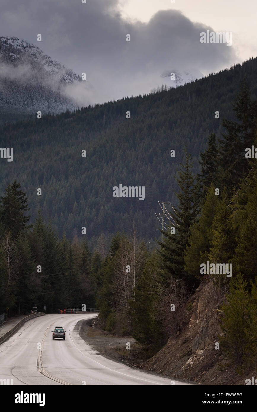 Car moving on road through coastal forest, BC Coast, Coast Mountains ...