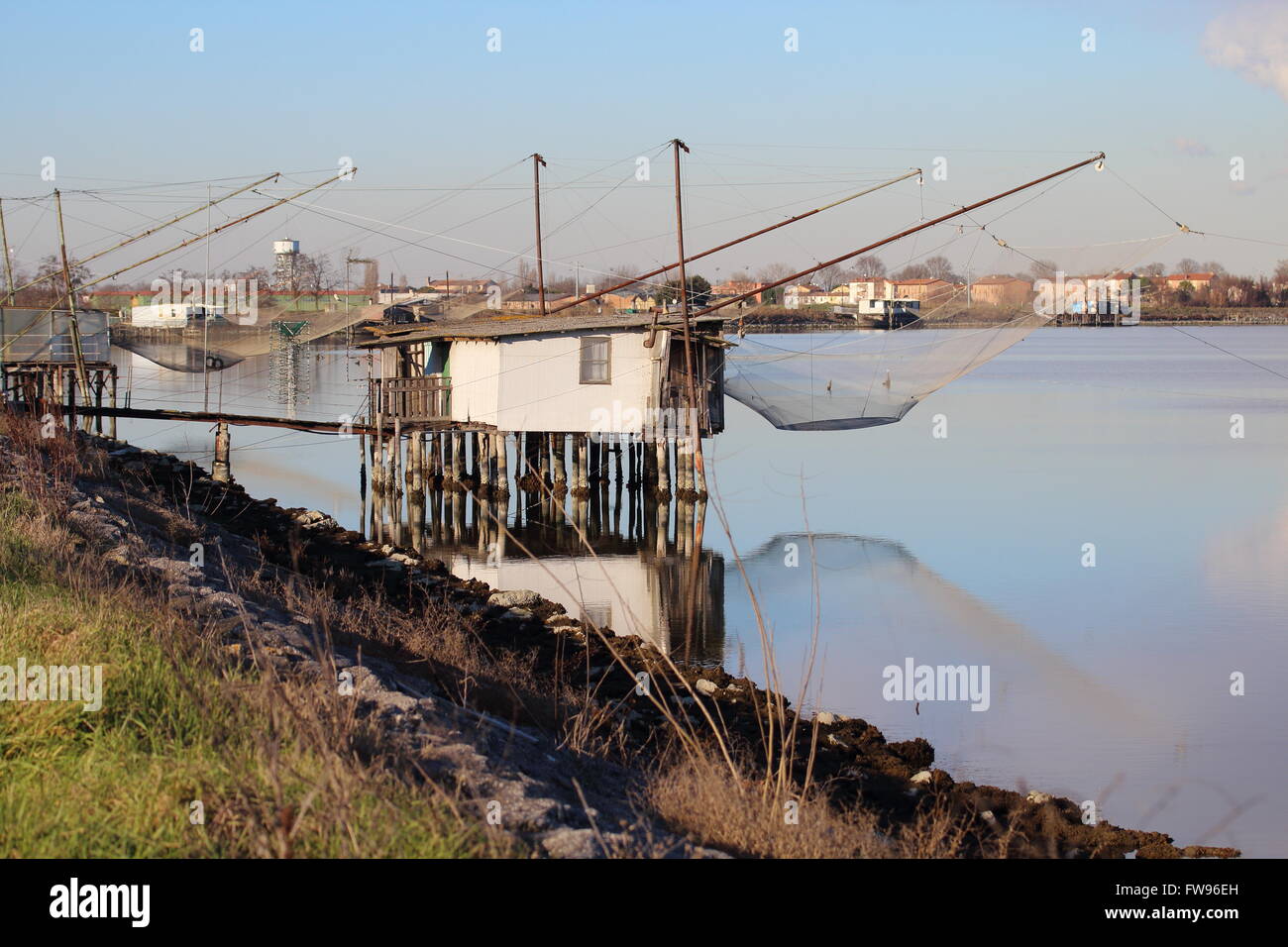 fishing huts with net on the canal of the lagoon Stock Photo - Alamy