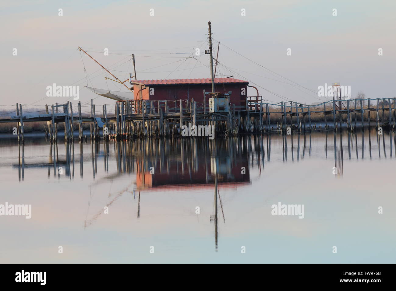 fishing huts with net on the canal of the lagoon Stock Photo - Alamy