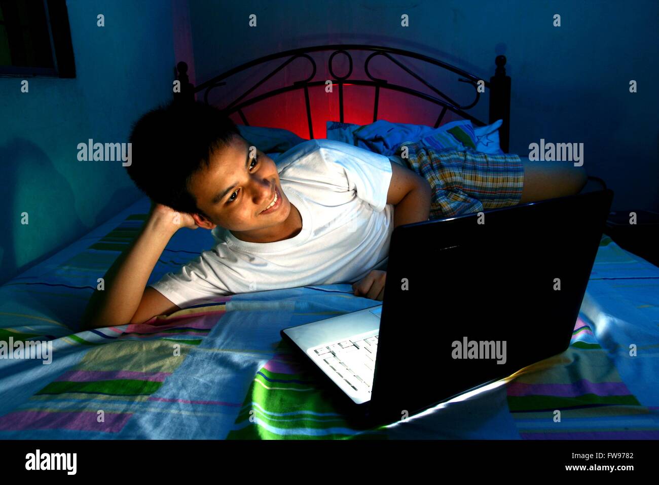 Young Teen sleeping front of a laptop computer and on a bed Stock Photo ...