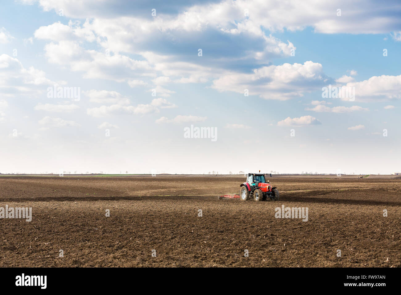 Farmer cultivating arable land before seeding Stock Photo - Alamy