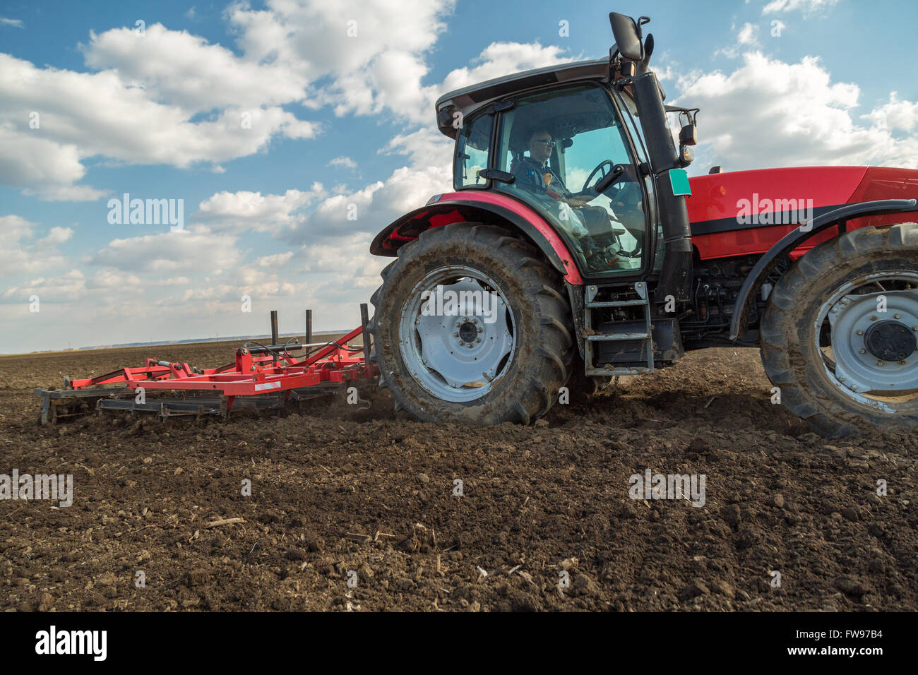 Farmer cultivating arable land before seeding Stock Photo - Alamy