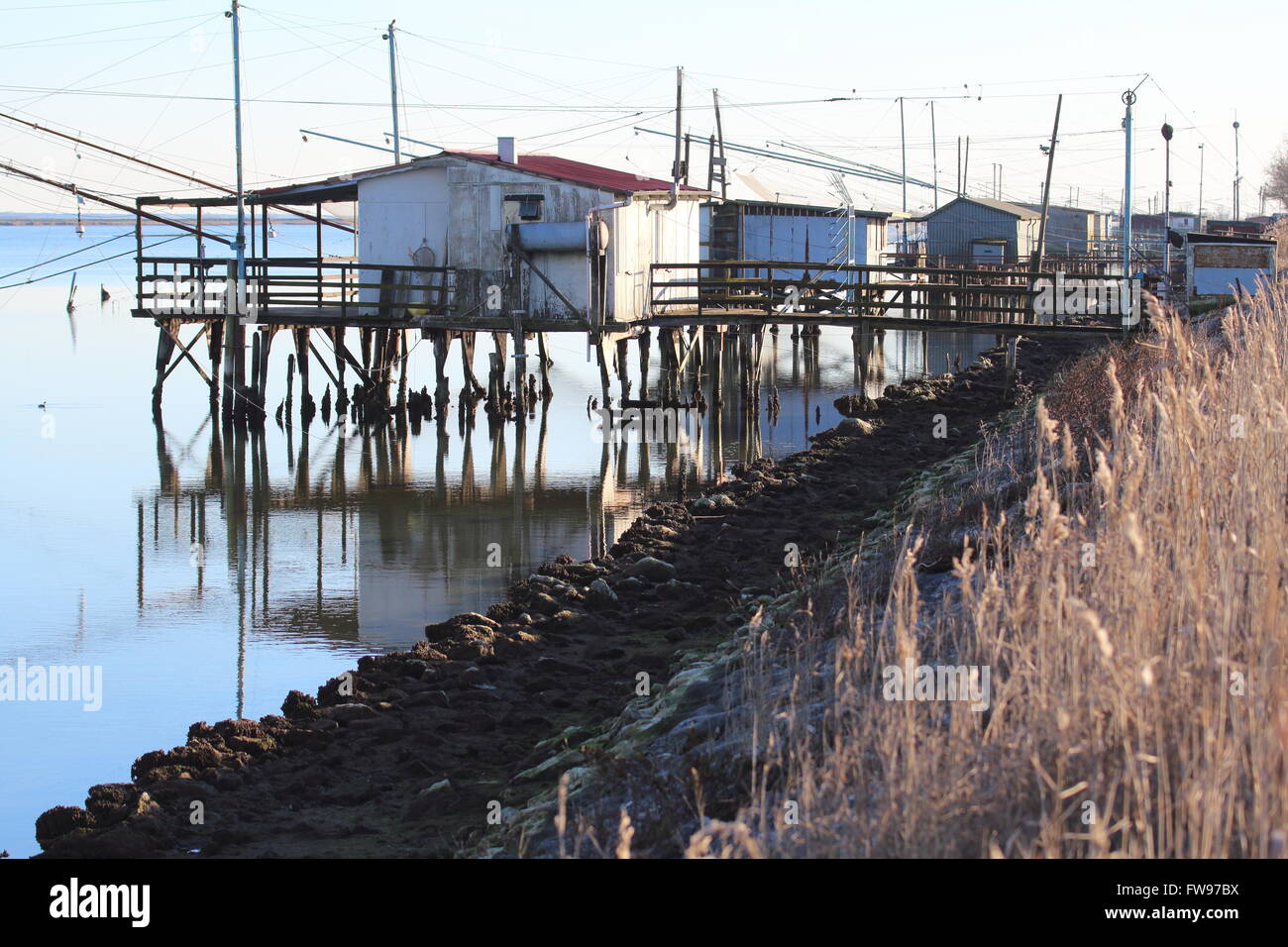fishing huts with net on the canal of the lagoon Stock Photo - Alamy
