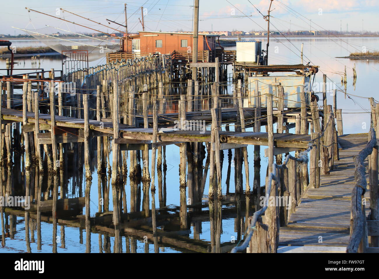 fishing huts with net on the canal of the lagoon Stock Photo - Alamy