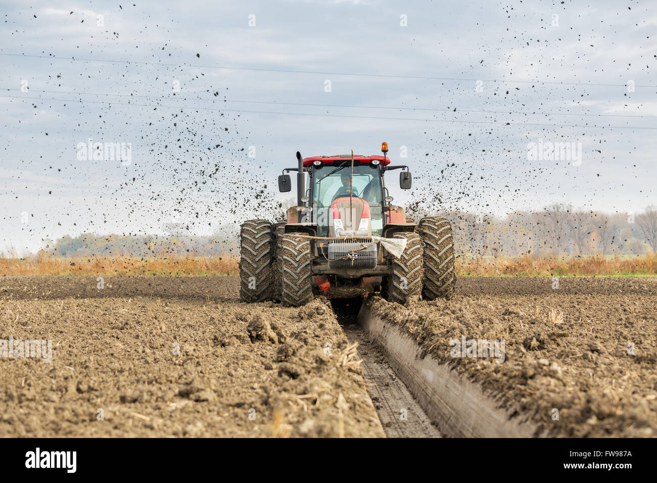 Tractor with double wheeled ditcher digging drainage canal Stock Photo ...