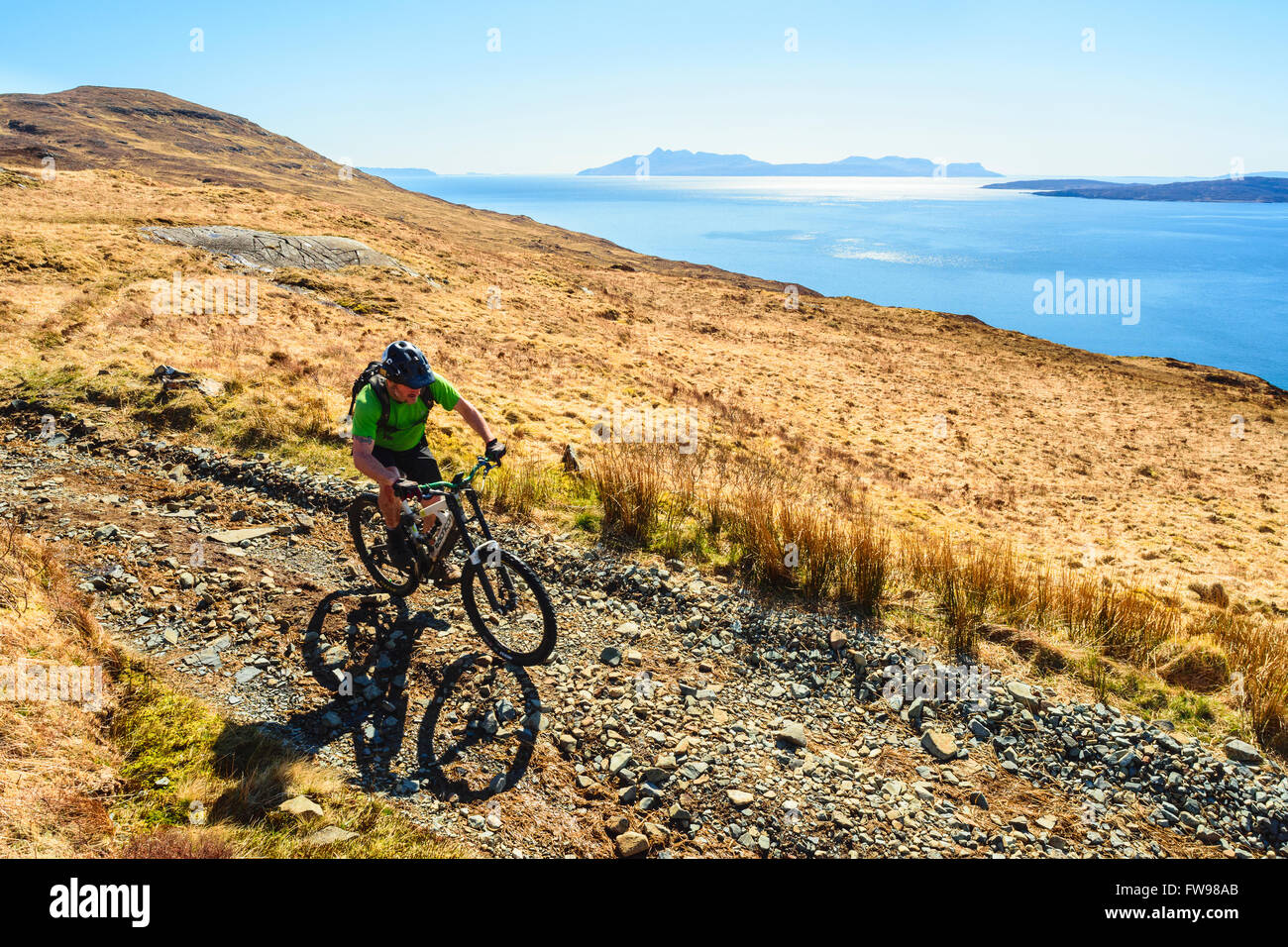 Mountain biker descending to Camasunary Isle of Skye Scotland with the ...