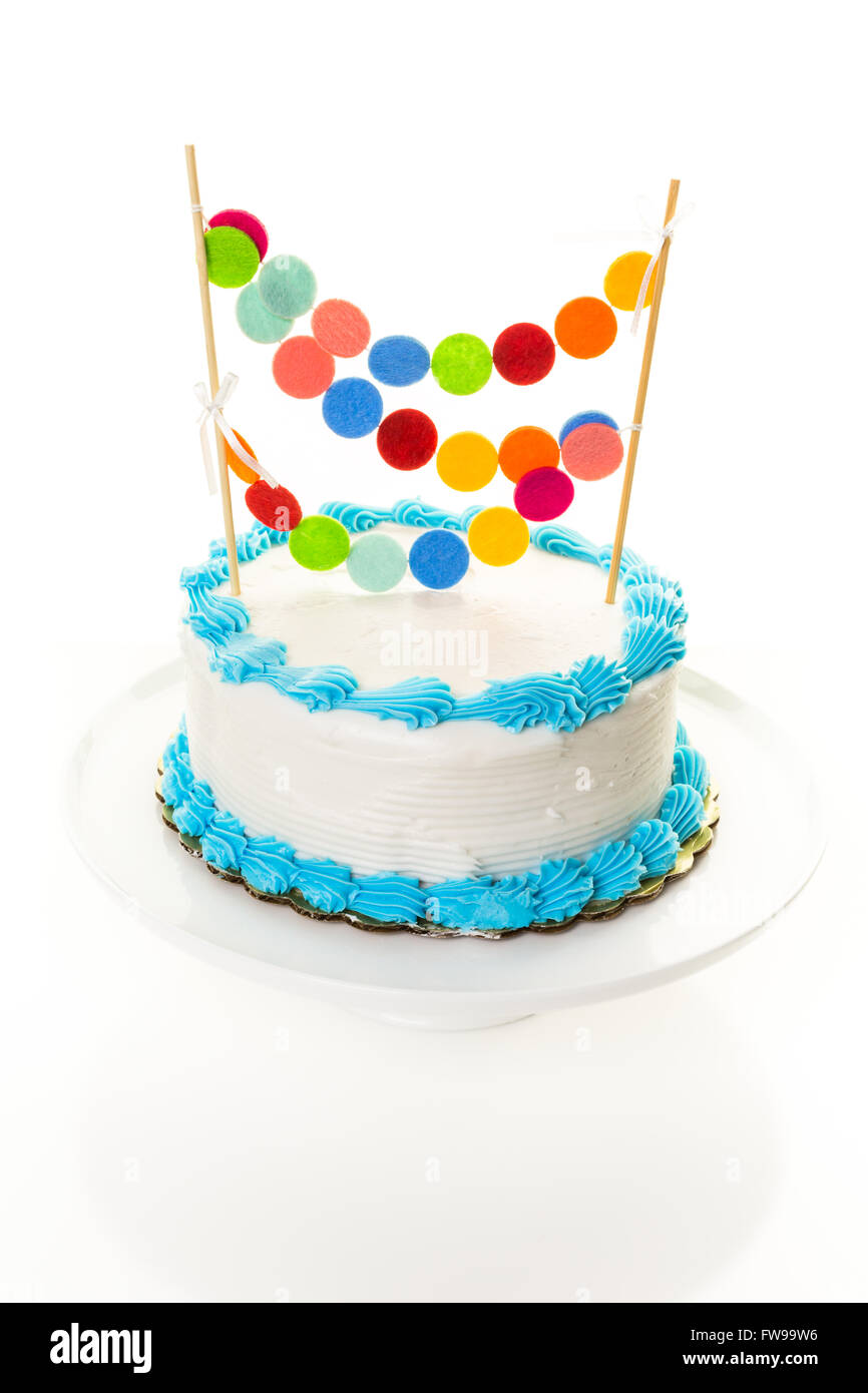 Simple white Birthday cake with cake garland Stock Photo - Alamy