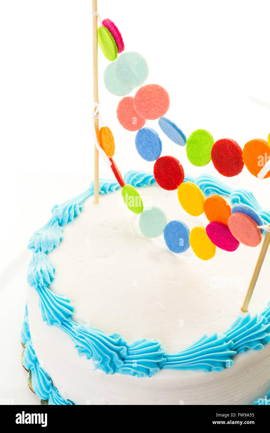 Simple white Birthday cake with cake garland Stock Photo - Alamy