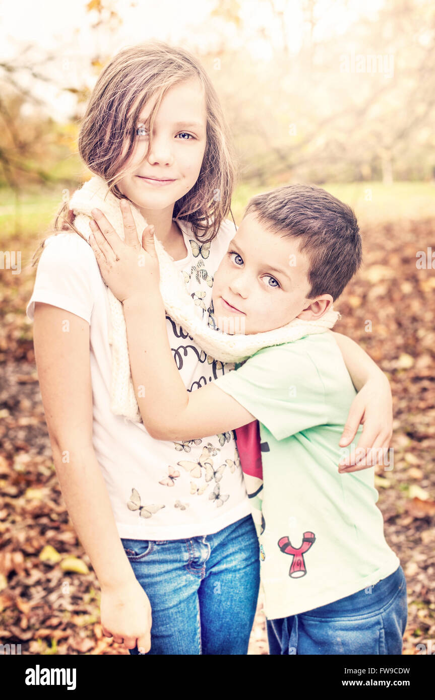 two children holding each other in autumn park Stock Photo - Alamy