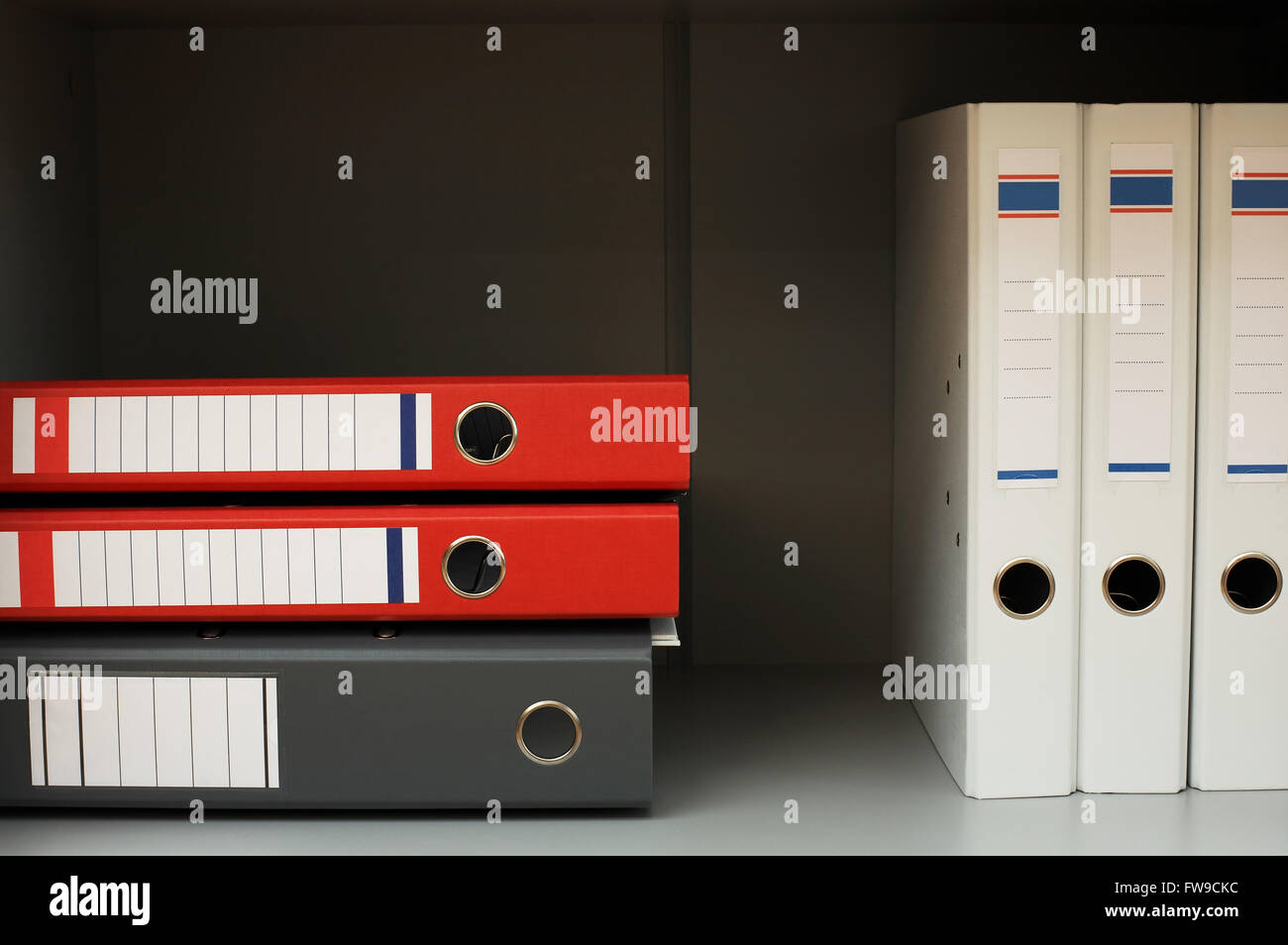 Folders for documents on a book shelf at office Stock Photo - Alamy