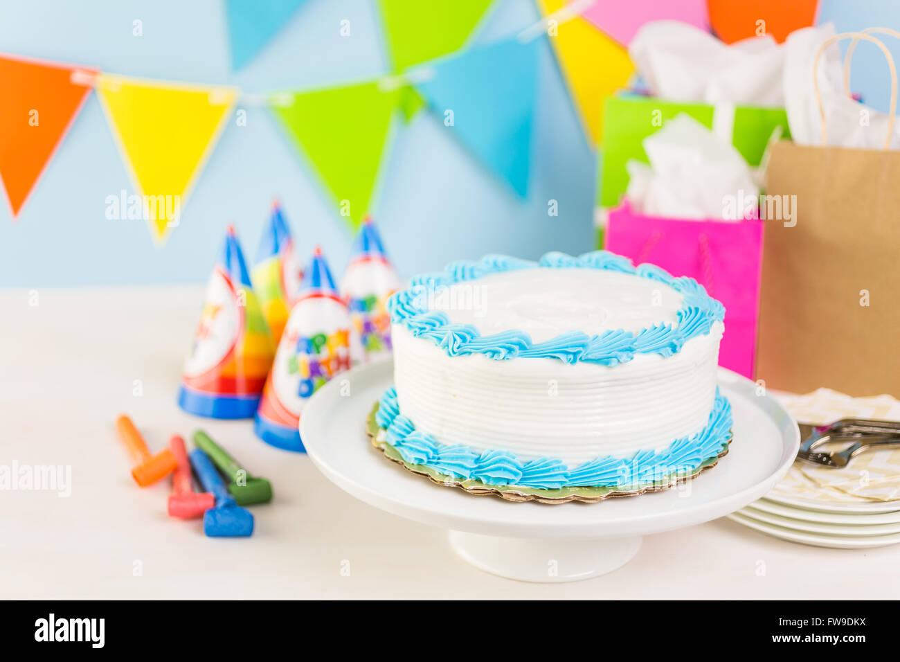 Simple white Birthday cake with white and blue icing Stock Photo - Alamy