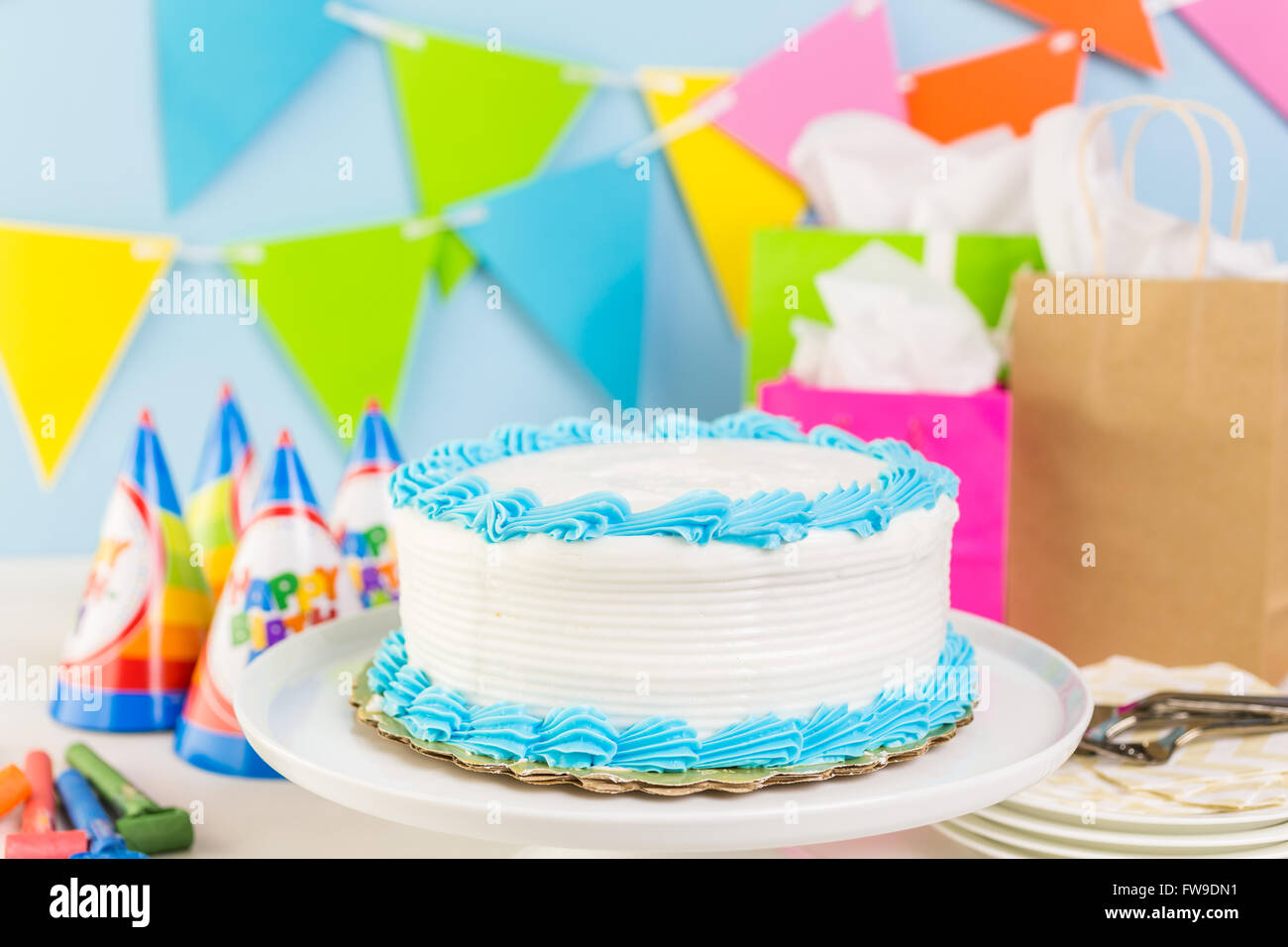 Simple white Birthday cake with white and blue icing Stock Photo - Alamy
