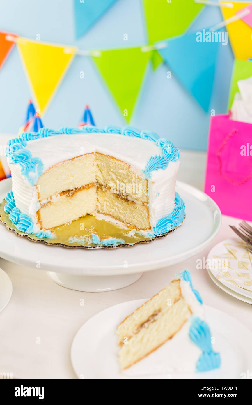 Simple white Birthday cake slice with white and blue icing Stock Photo ...