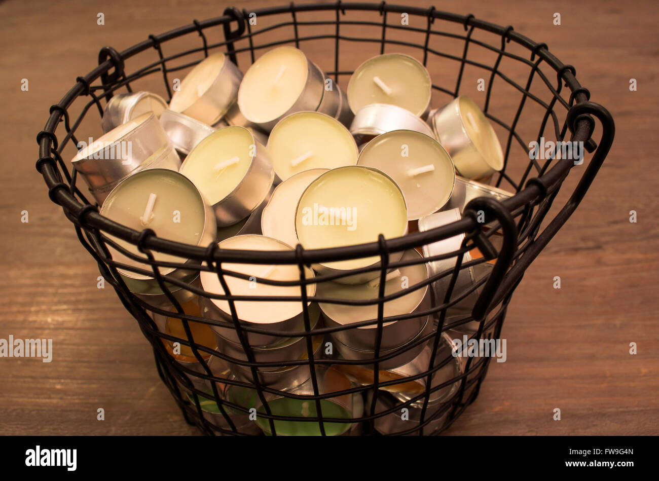 Tea lights in metal frame bowl Stock Photo - Alamy