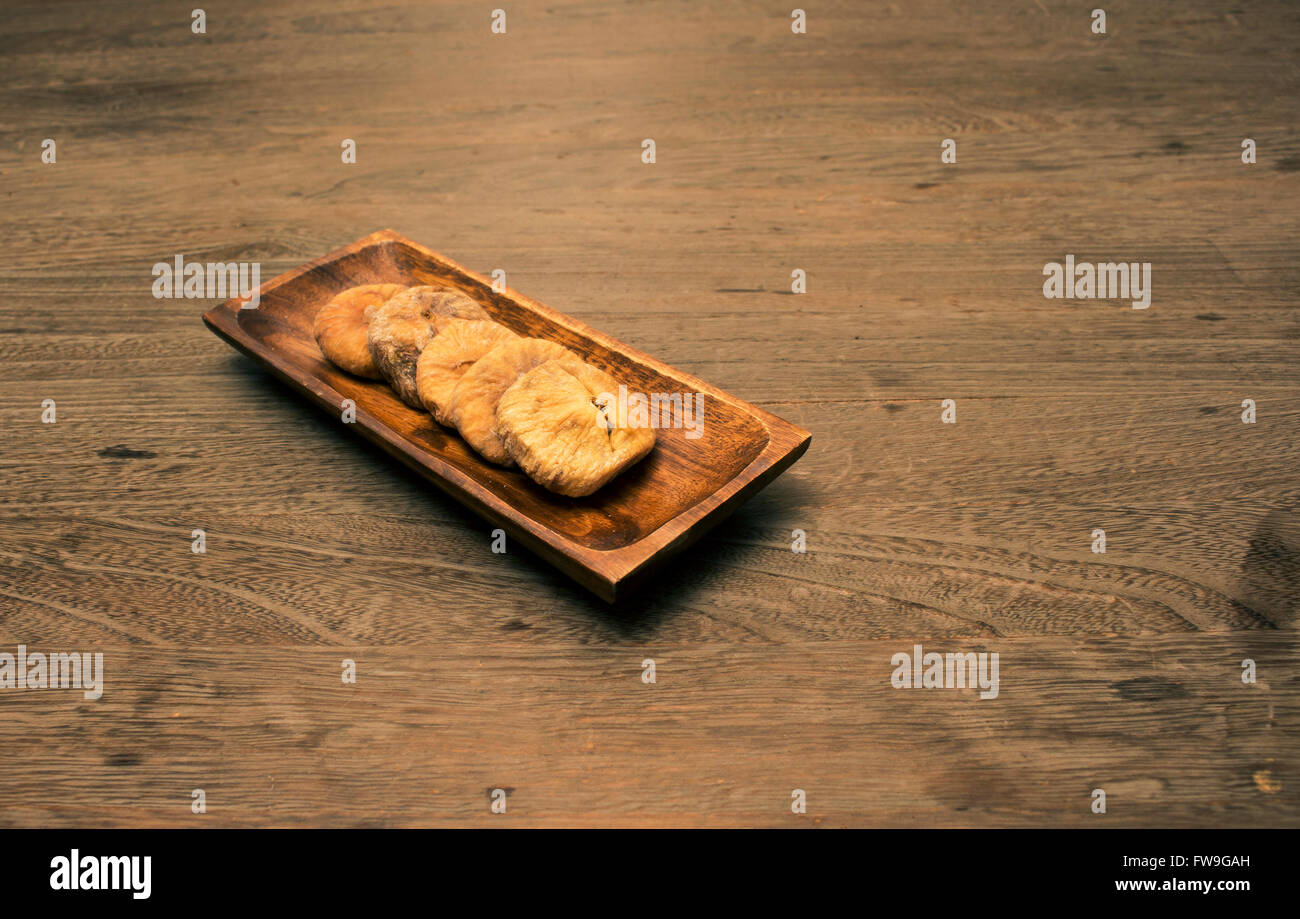 Fig in wood platter on wood background Stock Photo - Alamy