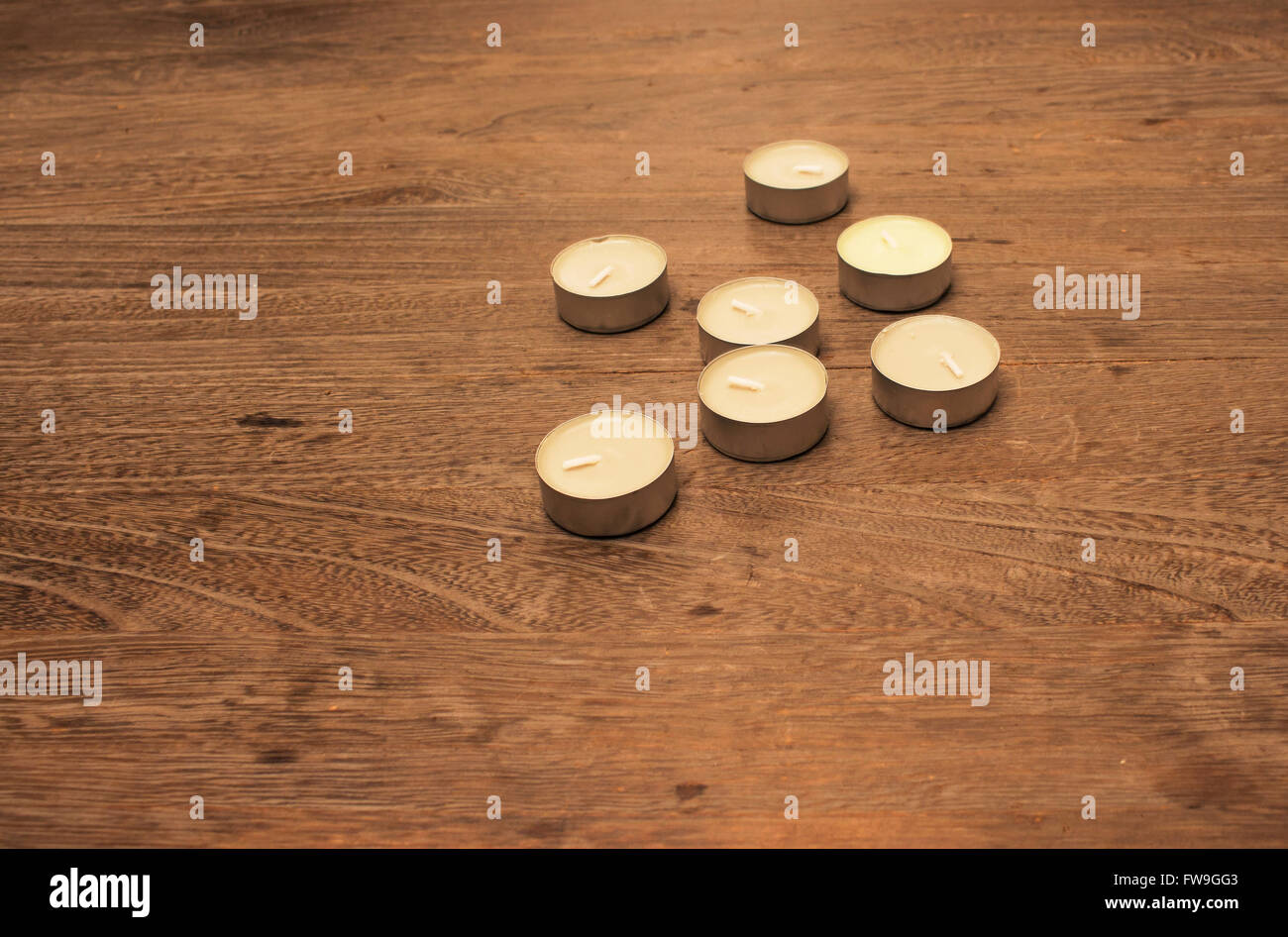 Tea-light on wood background Stock Photo - Alamy