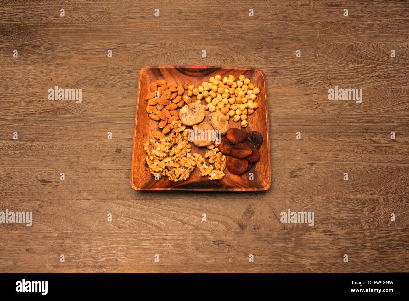assorted nuts in wood platter on wood table Stock Photo - Alamy