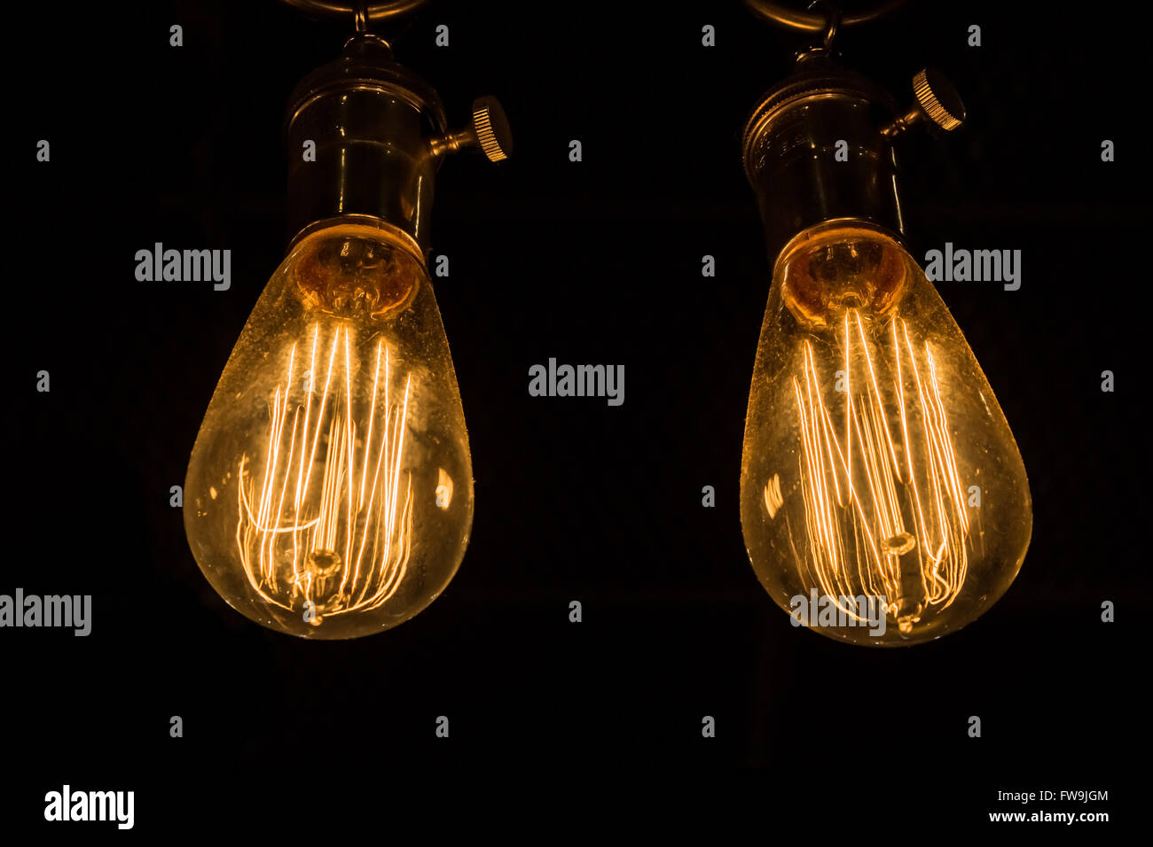 Vintage Edison Light Bulbs hanging against a black background Stock ...
