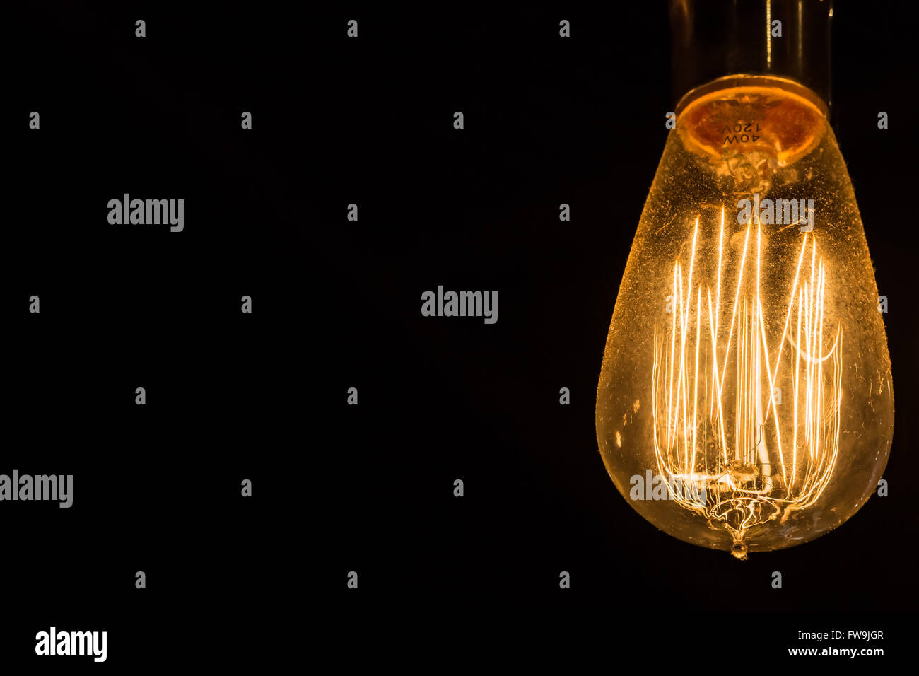 Vintage Edison Light Bulbs hanging against a black background Stock ...