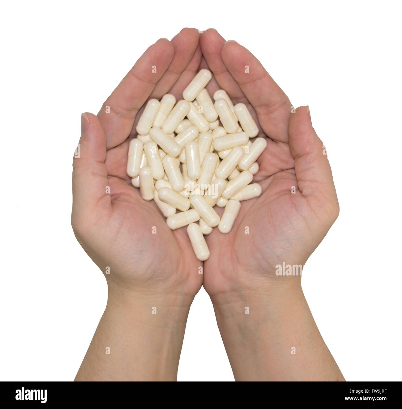 A lot of pills in hands on isolated background Stock Photo - Alamy
