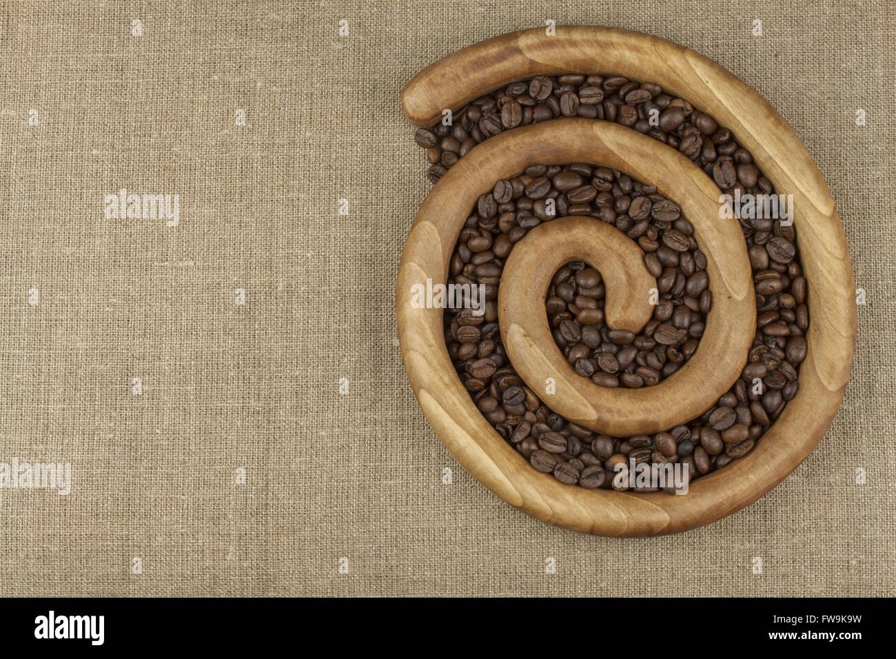 We love fresh roasted coffee. Roasted coffee beans in a wooden spiral ...