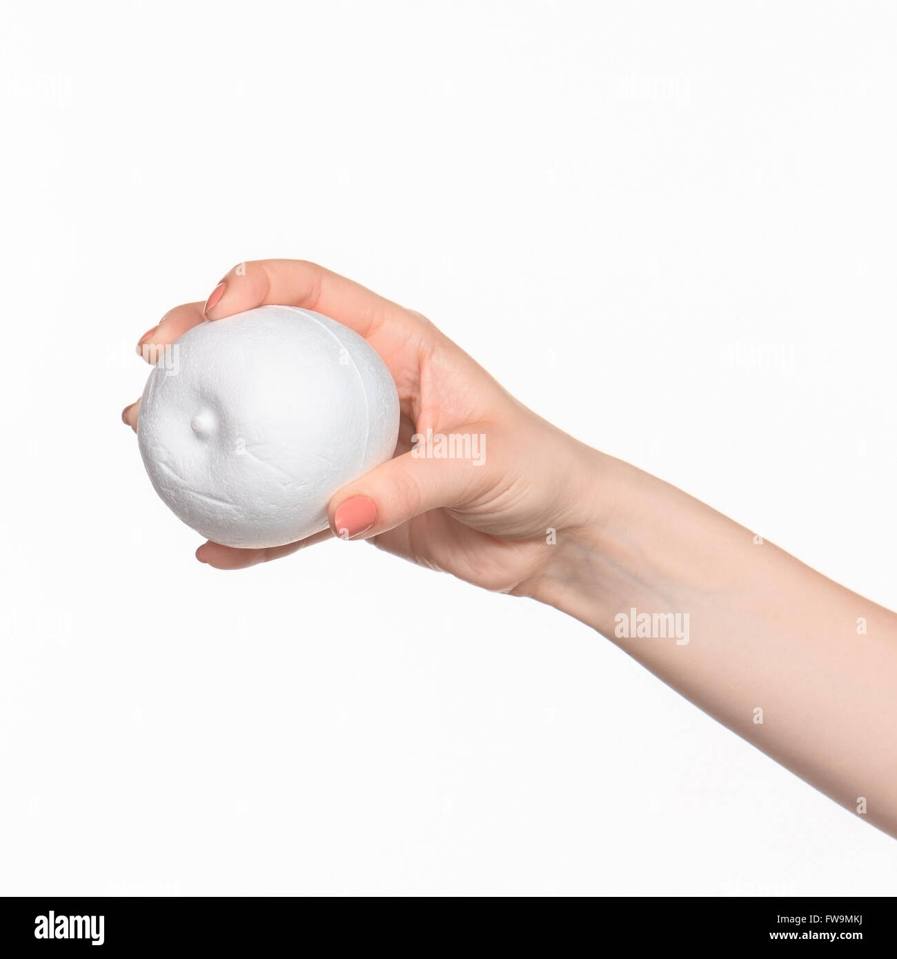 The female hand holding white blank styrofoam oval against the white ...