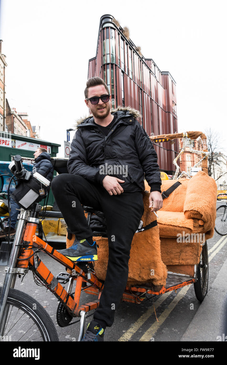 A London rickshaw driver takes a rest on Oxford Street, UK Stock Photo ...