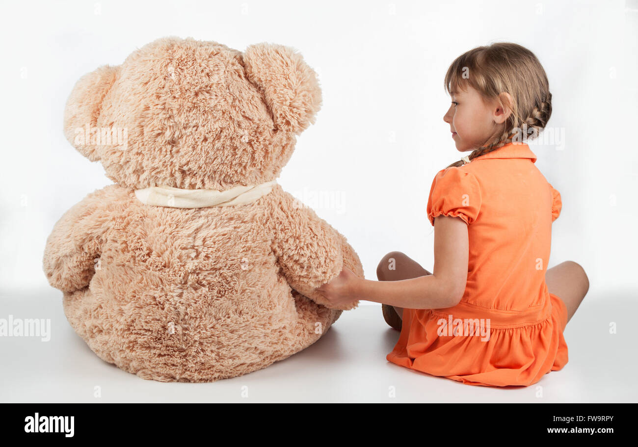 Child playing with a plush toy, soft toy. Funny baby with a soft toy ...