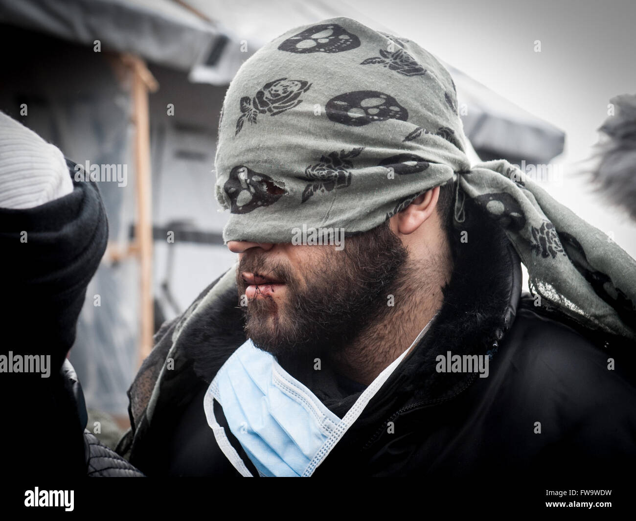 A group of Iranian asylum seekers stitch up their mouths to signify ...