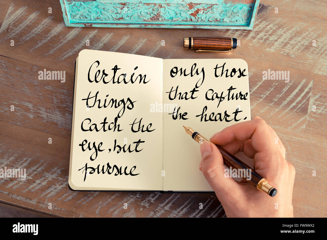 Retro effect and toned image of a woman hand writing on a notebook ...