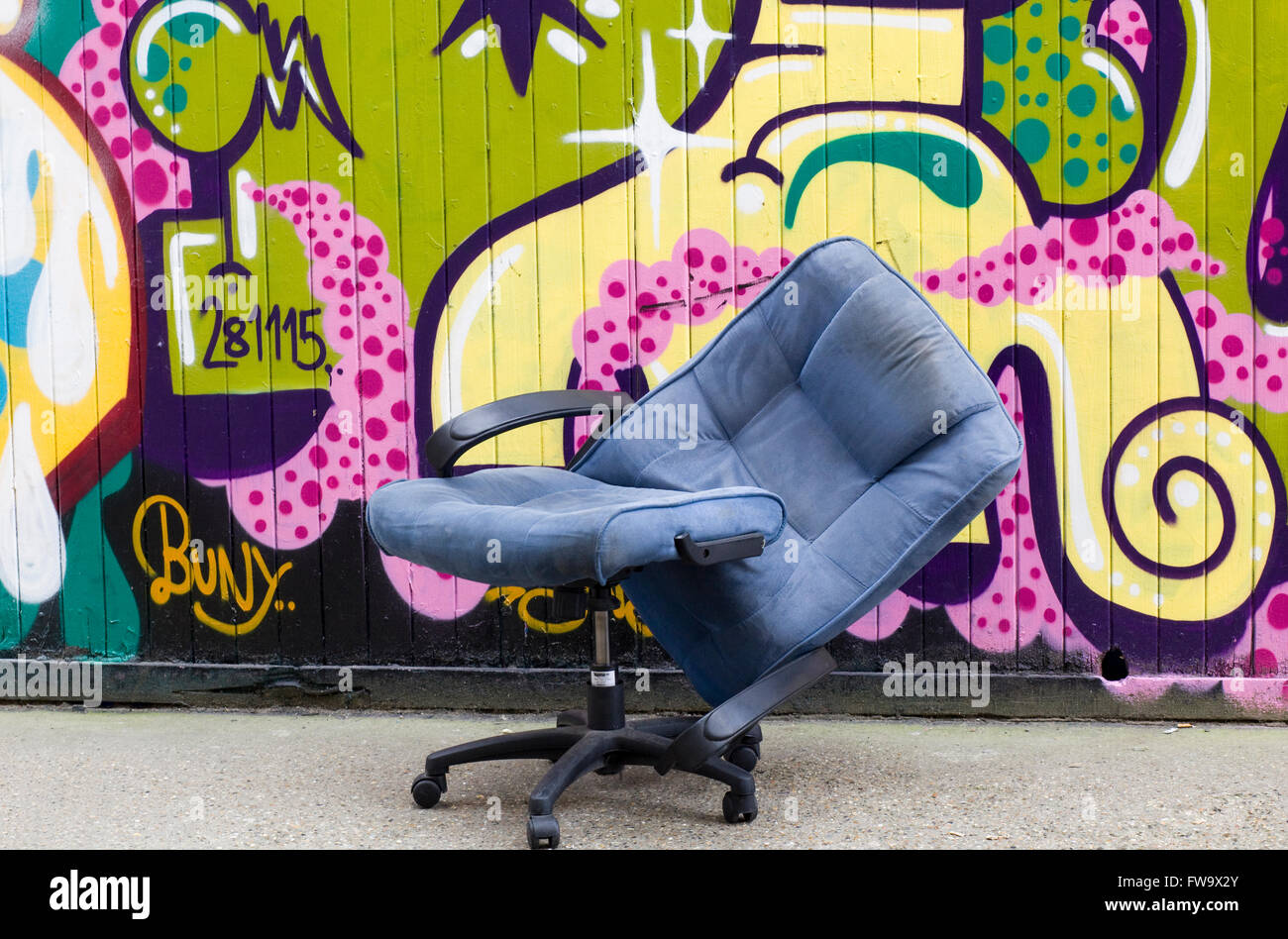 Broken chair on street in front of Approved Wall Art Graffiti Stock ...