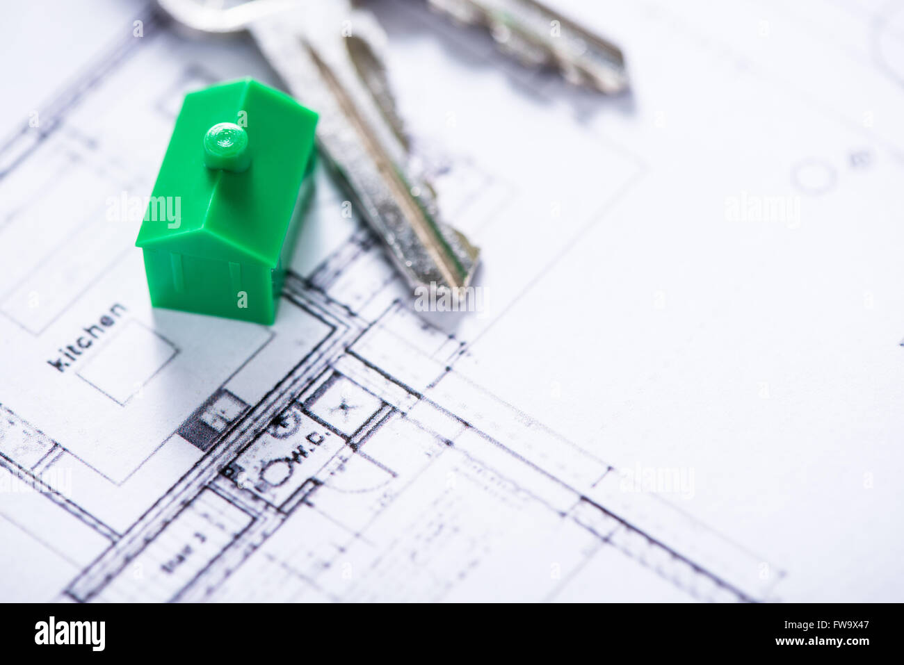 estate agent selling house, keys on architect drawings Stock Photo - Alamy