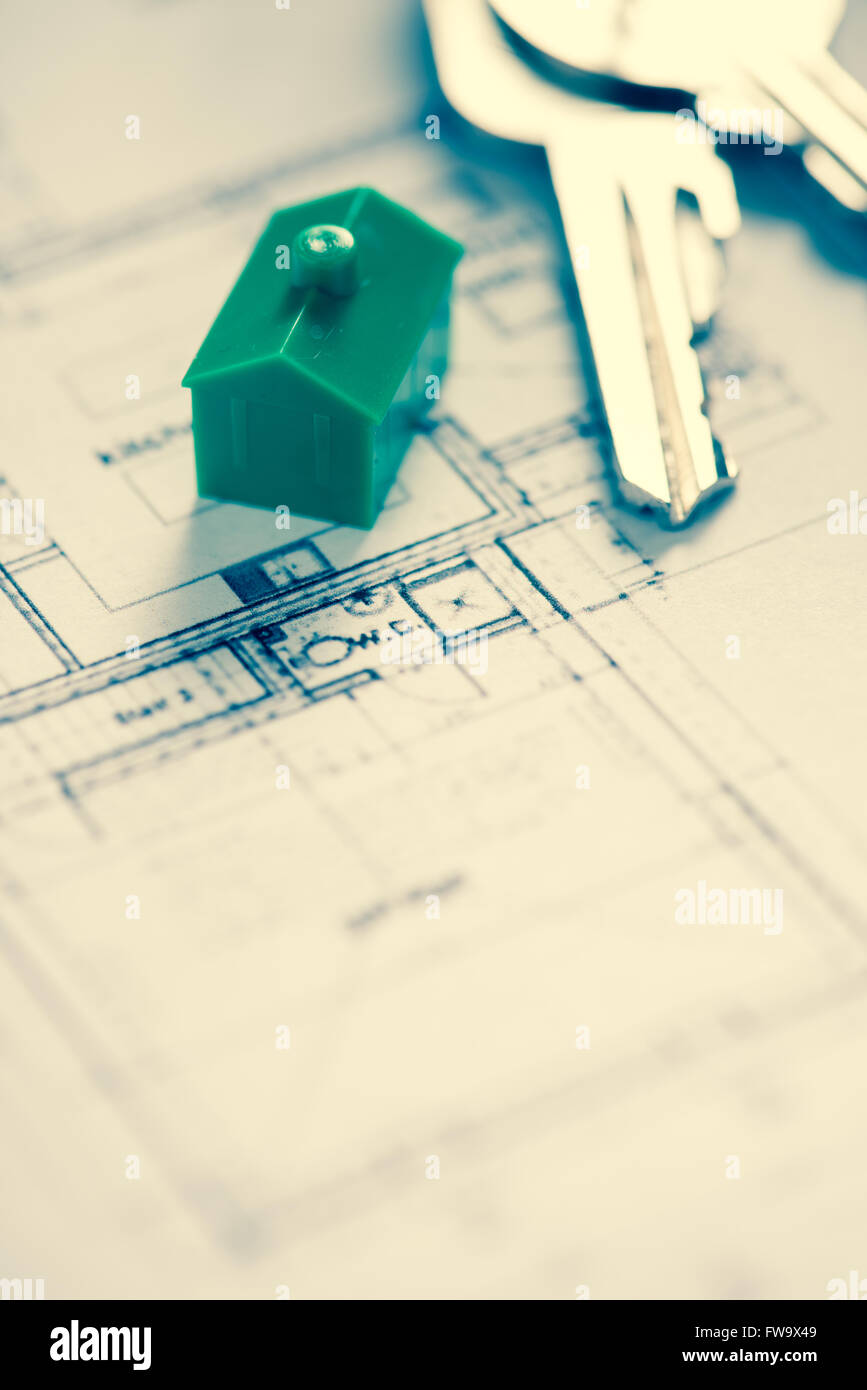 estate agent selling house, keys on architect drawings Stock Photo - Alamy