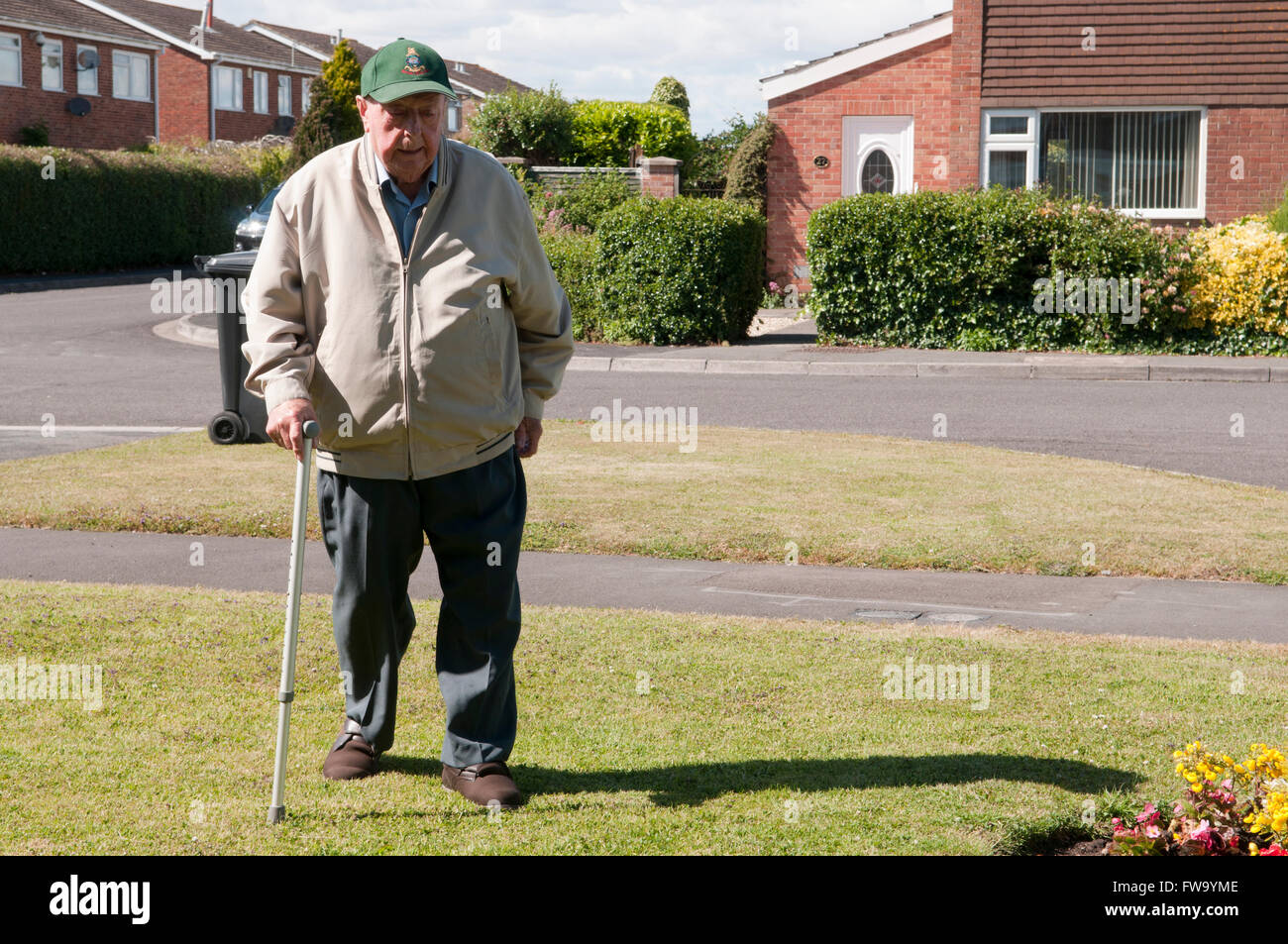 Elderly man walking with a stick Stock Photo - Alamy
