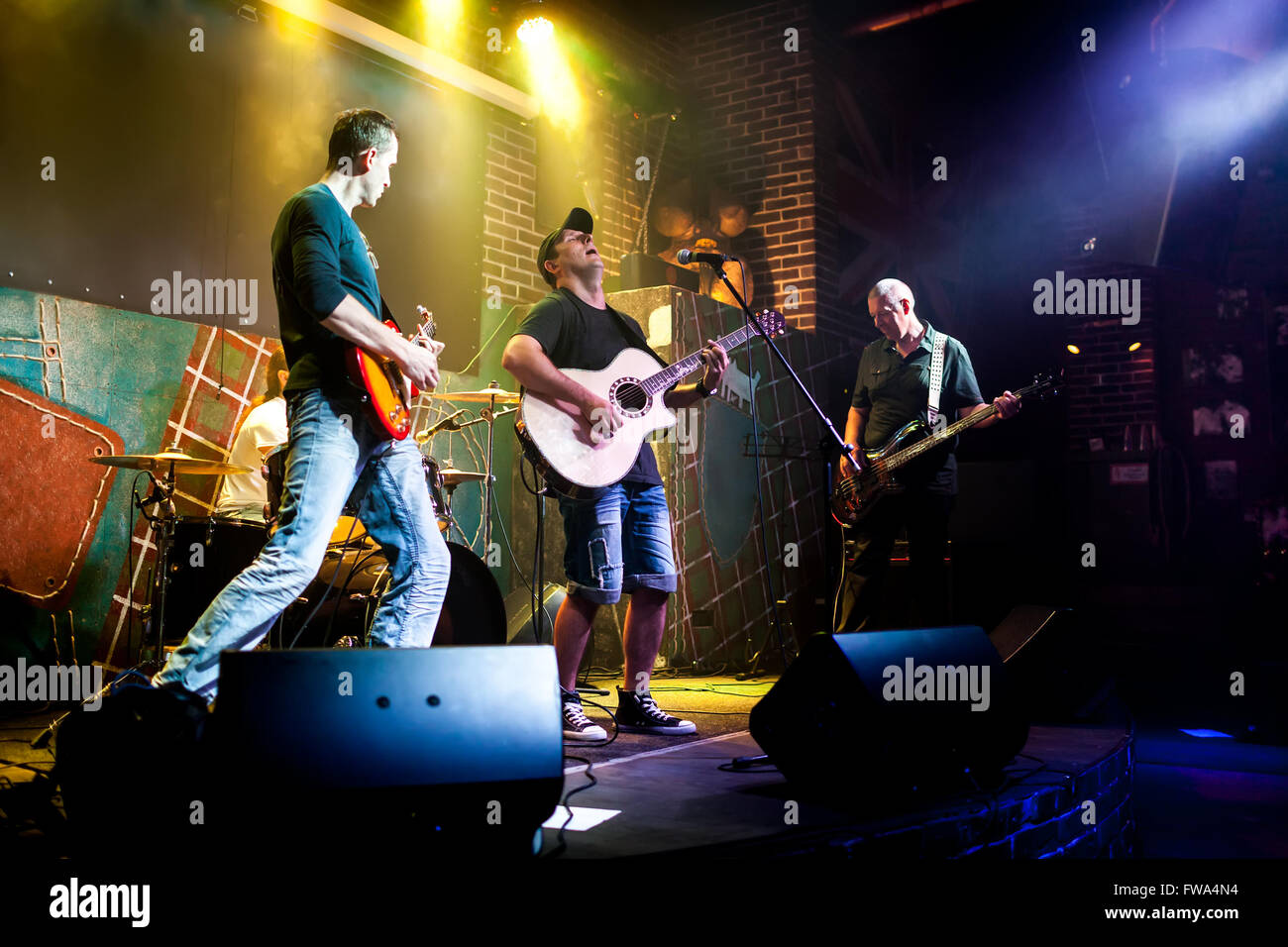 Band performs on stage, rock music concert. Warning - authentic ...