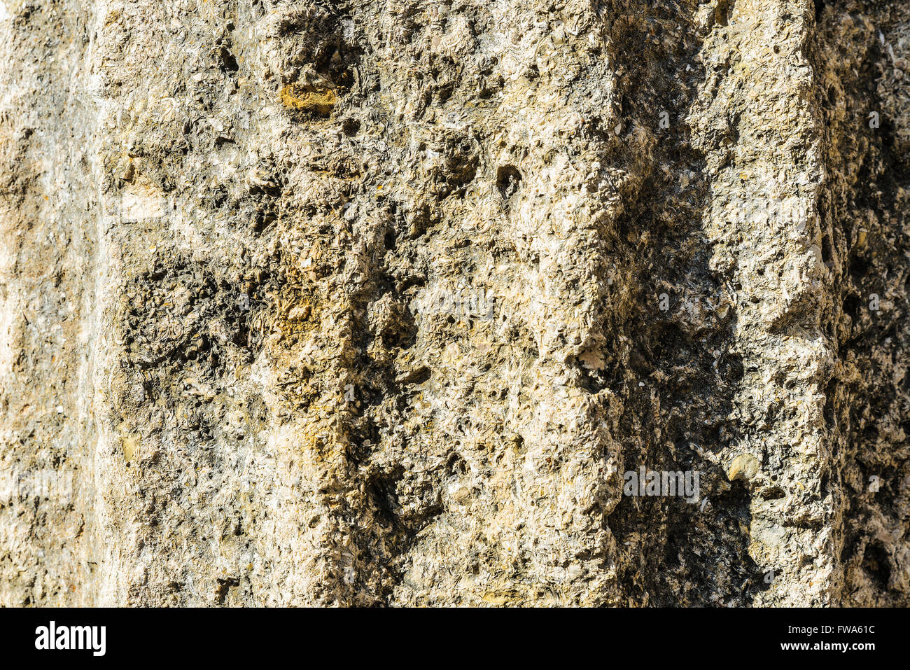 Eroded stone wall with holes as background Stock Photo - Alamy