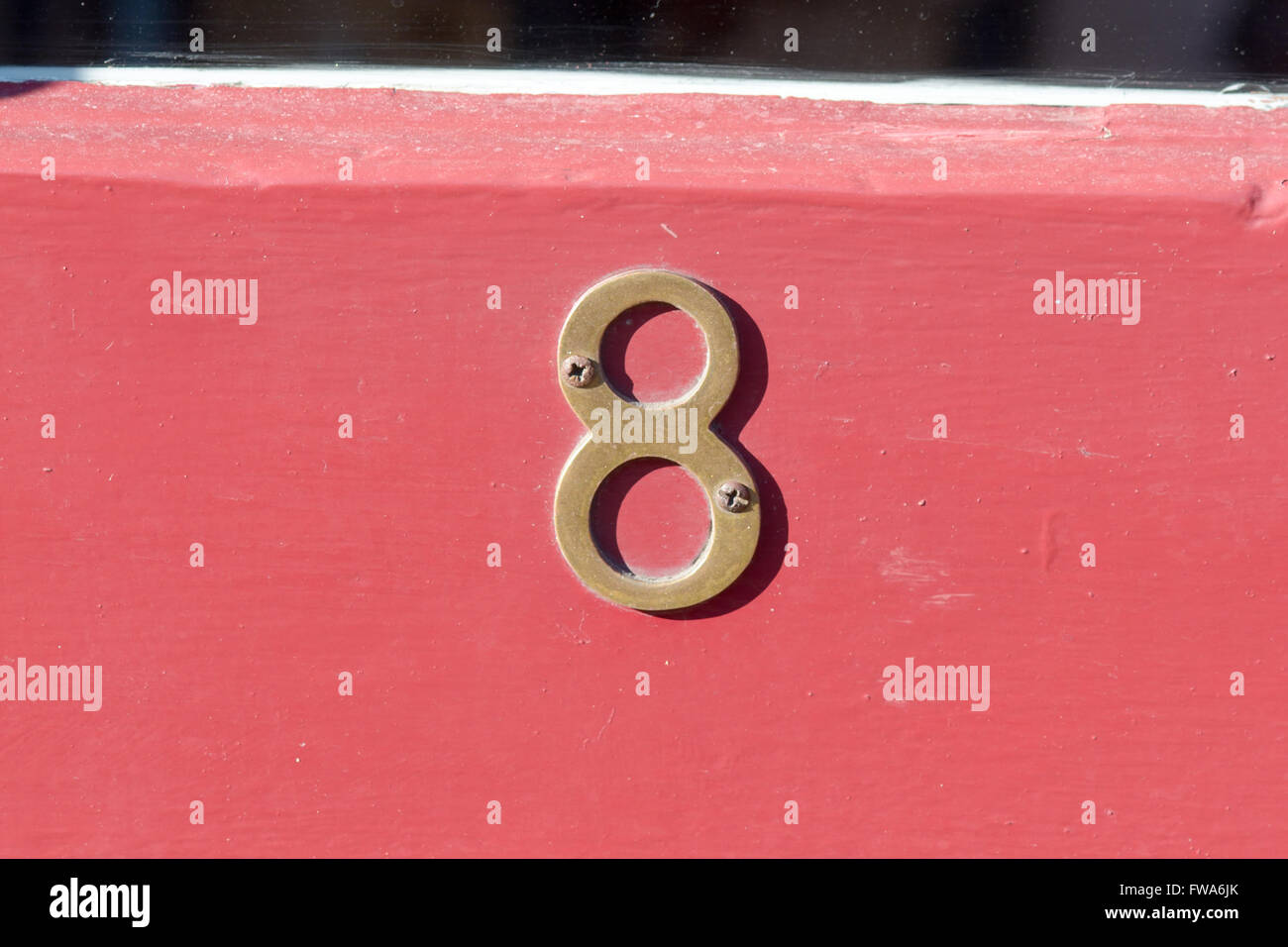 House number 8 sign on wooden fence Stock Photo - Alamy