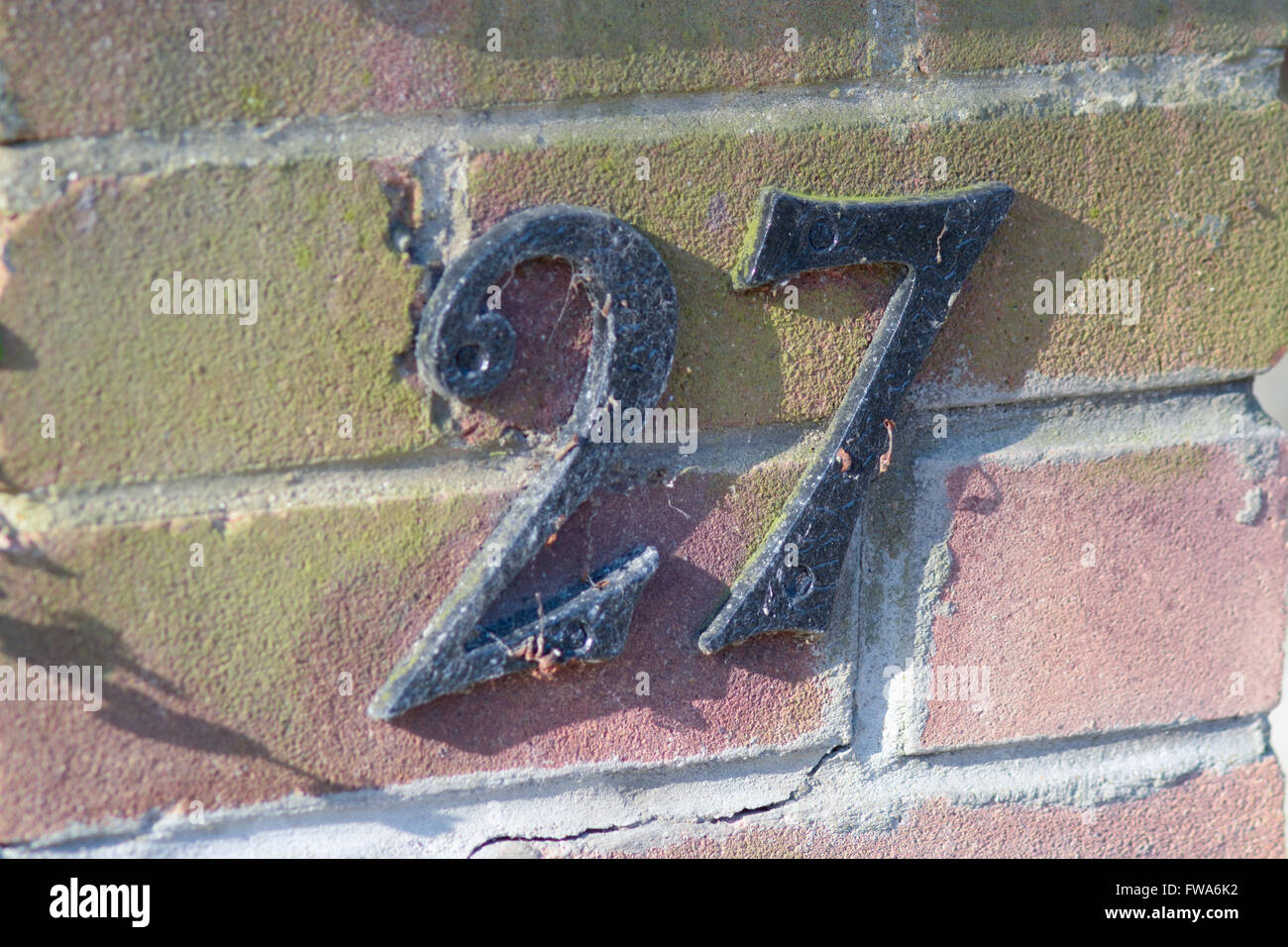 House number 27 sign on wall Stock Photo - Alamy