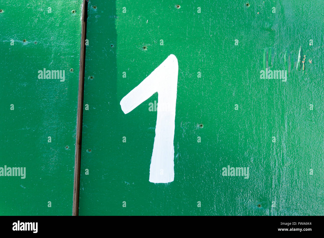 House number 1 sign - white paint on green background Stock Photo - Alamy