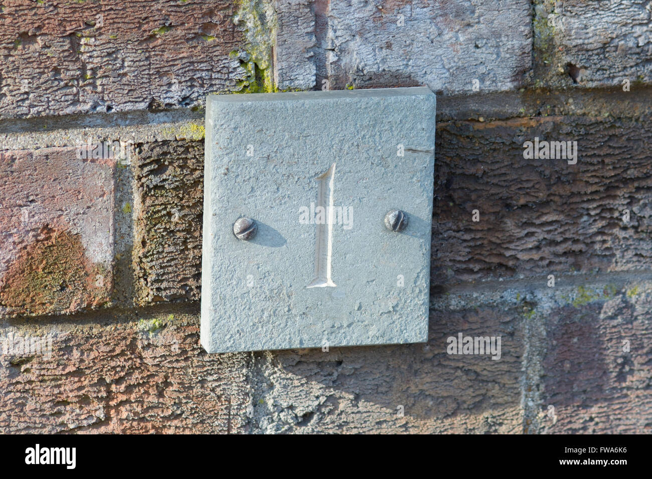House number 1 sign - grey tile on wall Stock Photo - Alamy