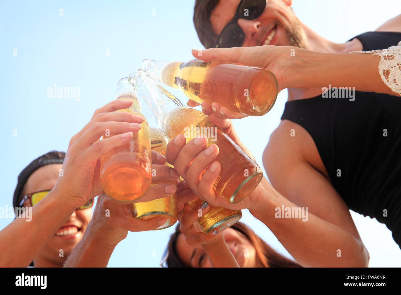 Happy young friends drinking beer outdoors Stock Photo - Alamy