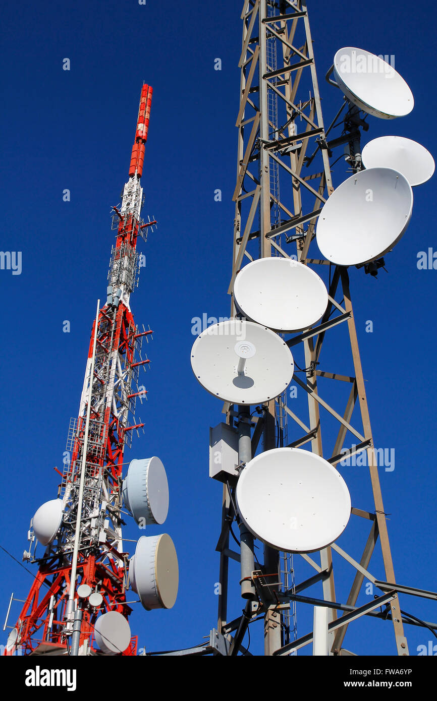 Telecommunications tower against blue sky Stock Photo - Alamy