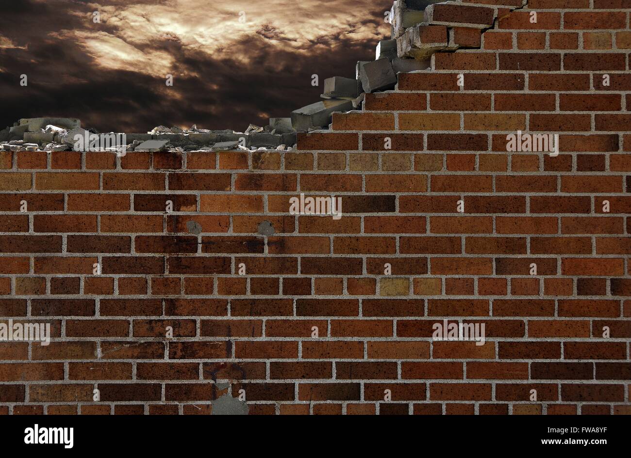 Crumbling brick wall with stormy sky background Stock Photo - Alamy