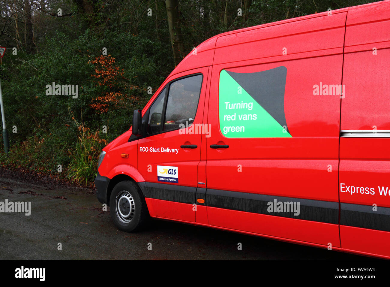 Parcelforce ECO-Start delivery van parked on roadside in woodland ...